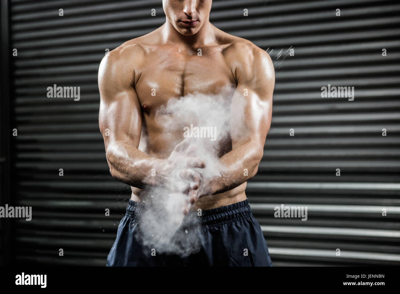 Shirtless man clapping hands with talc Stock Photo - Alamy