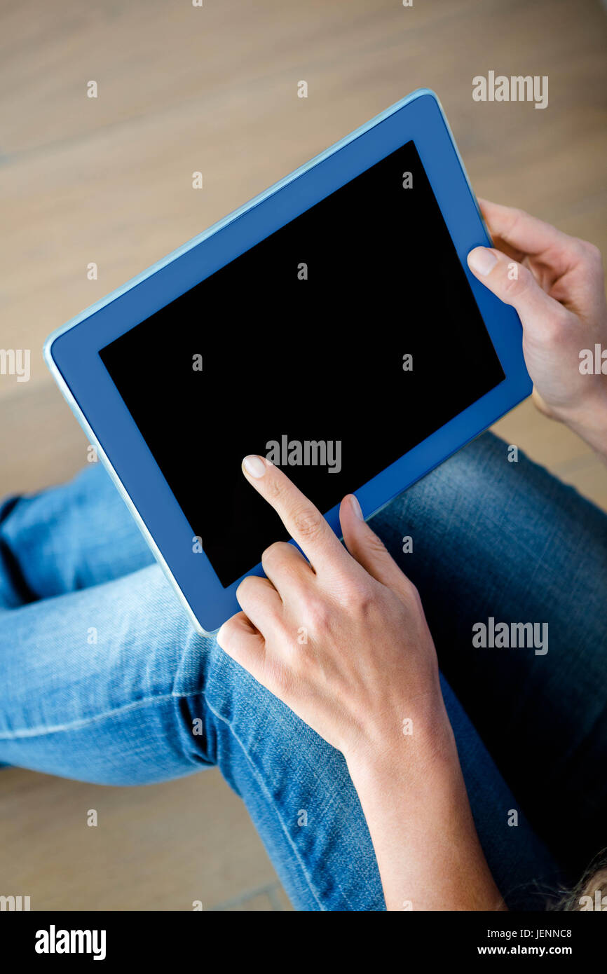 finger tapping a touchscreen tablet Stock Photo - Alamy
