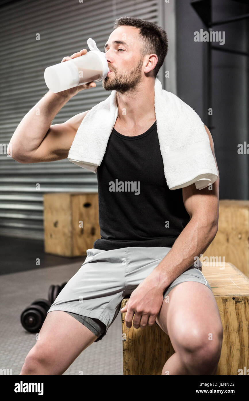 Muscular man drinking protein shake Stock Photo - Alamy