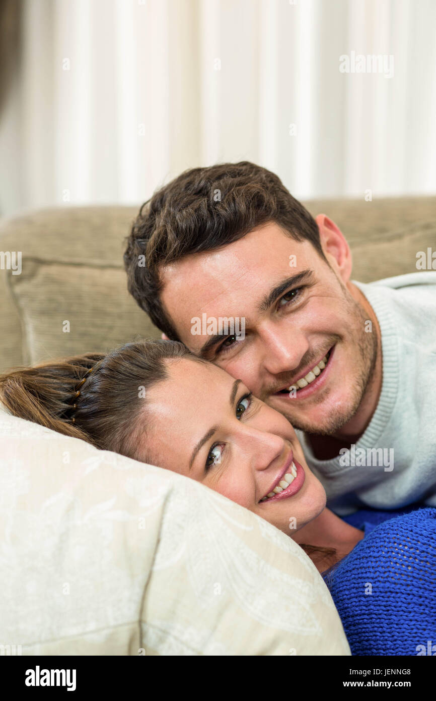 Couple cuddling up on sofa hi-res stock photography and images - Alamy
