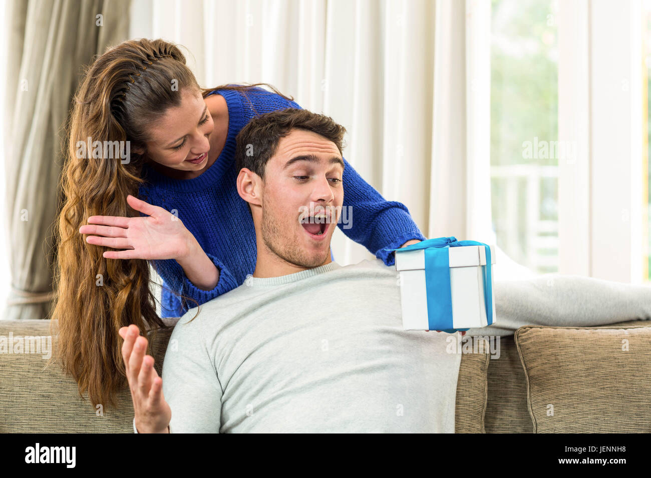 Man receiving a surprise gift Stock Photo - Alamy