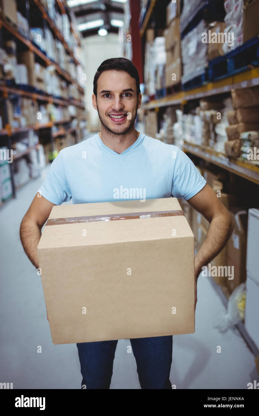 Smiling man holding big box Stock Photo - Alamy