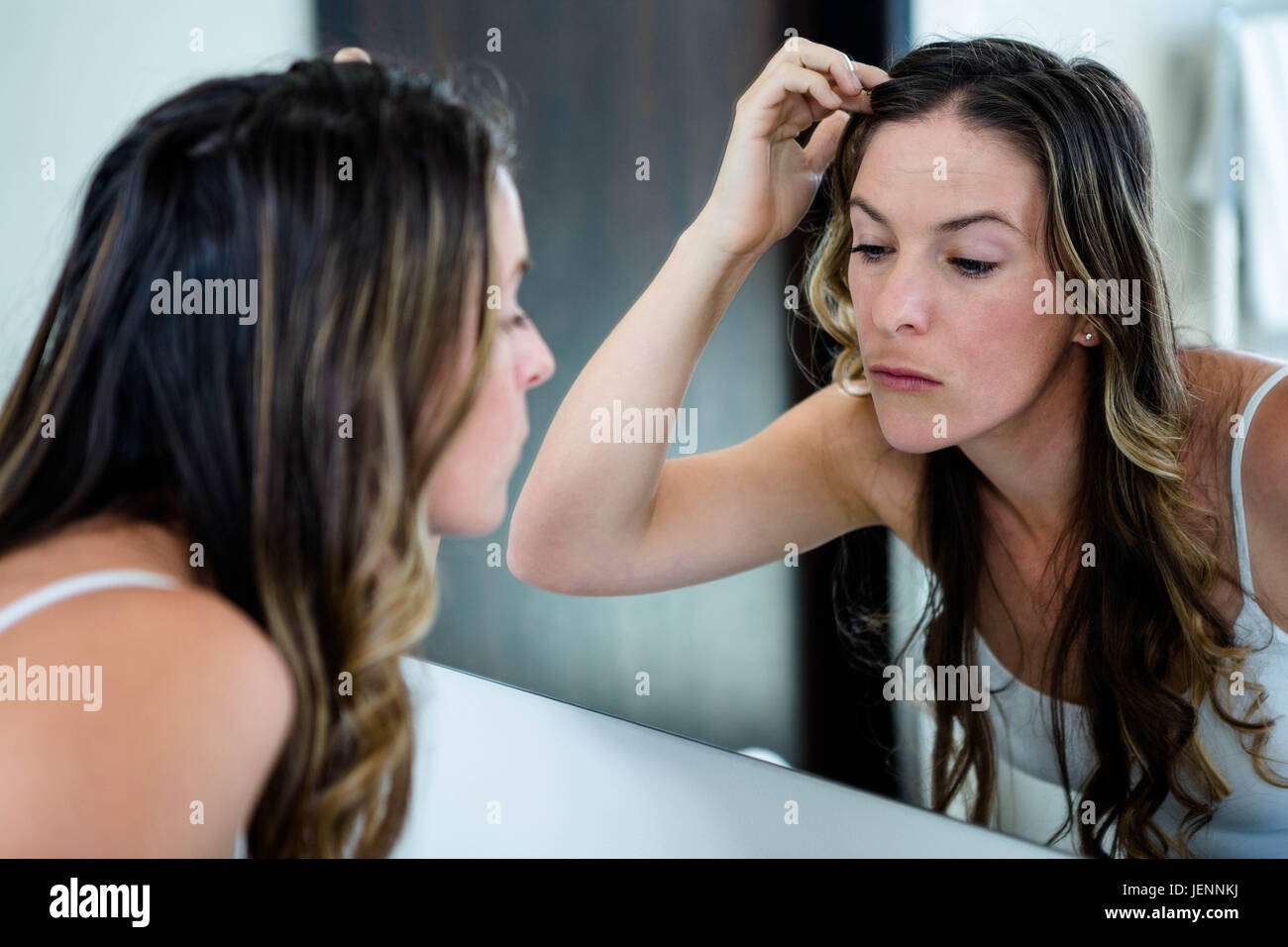 thoughtful woman looking t her reflection Stock Photo - Alamy