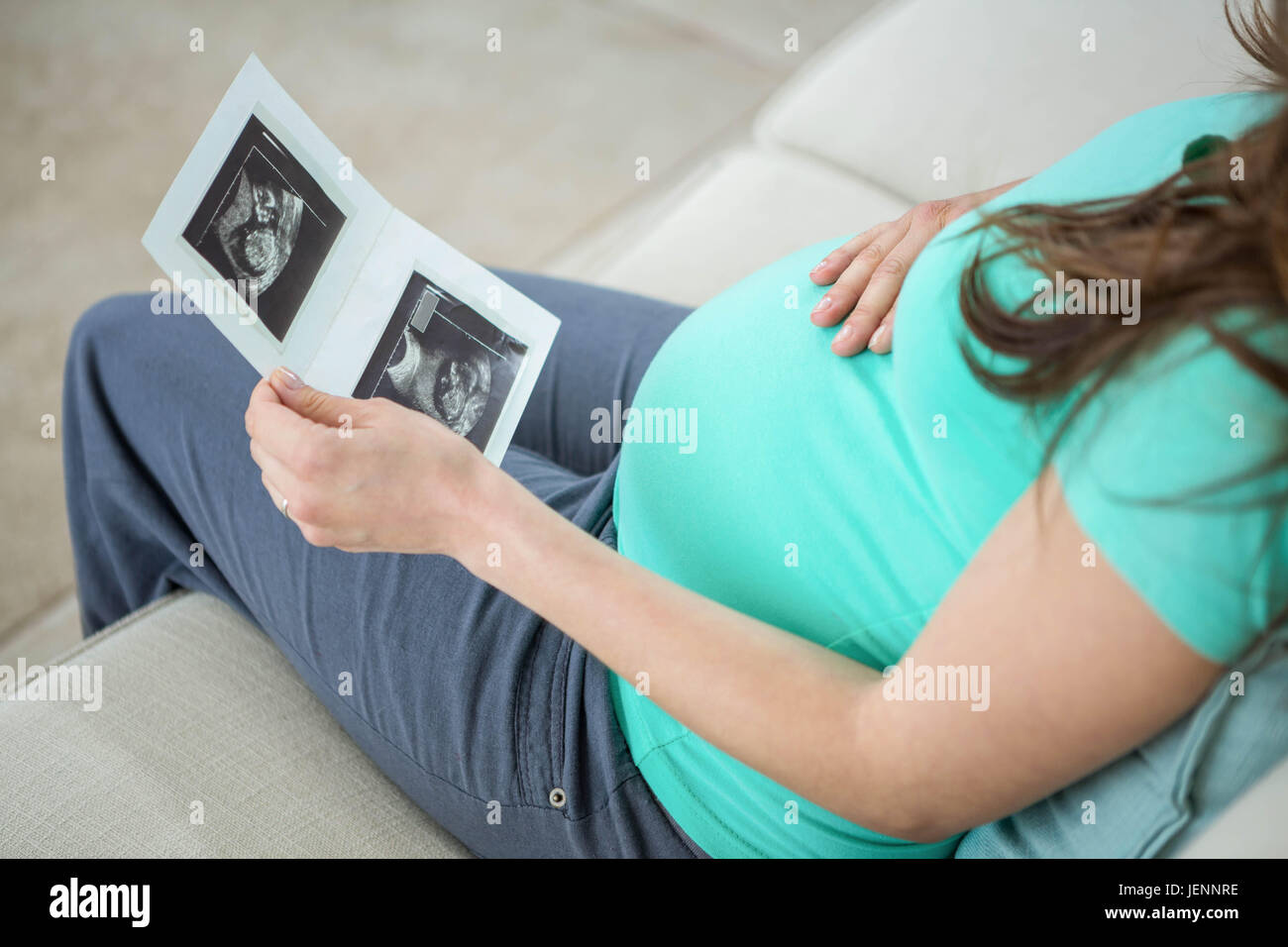 Pregnant woman looking at ultrasound scans Stock Photo - Alamy