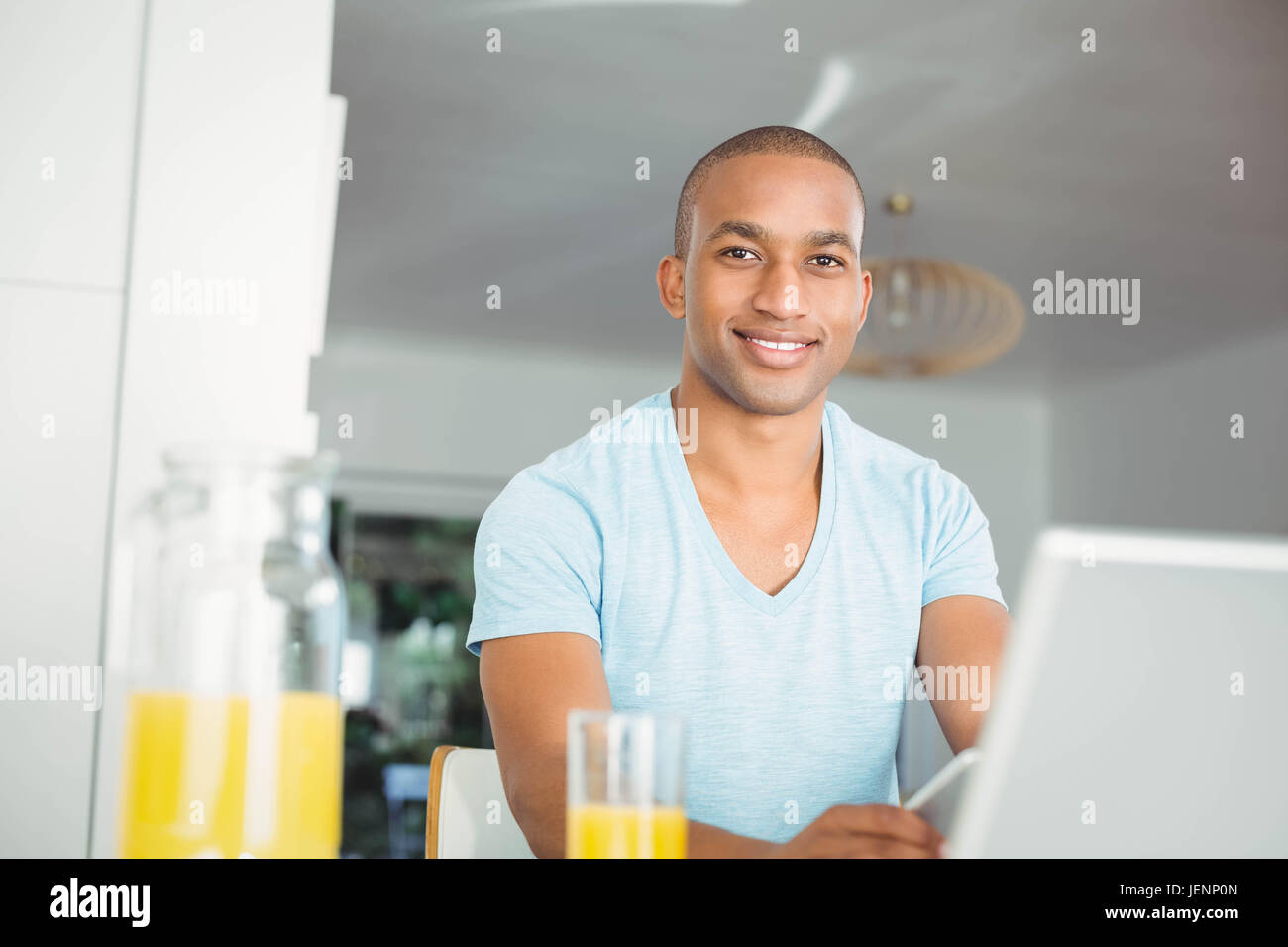 Handsome man smiling at the camera Stock Photo - Alamy
