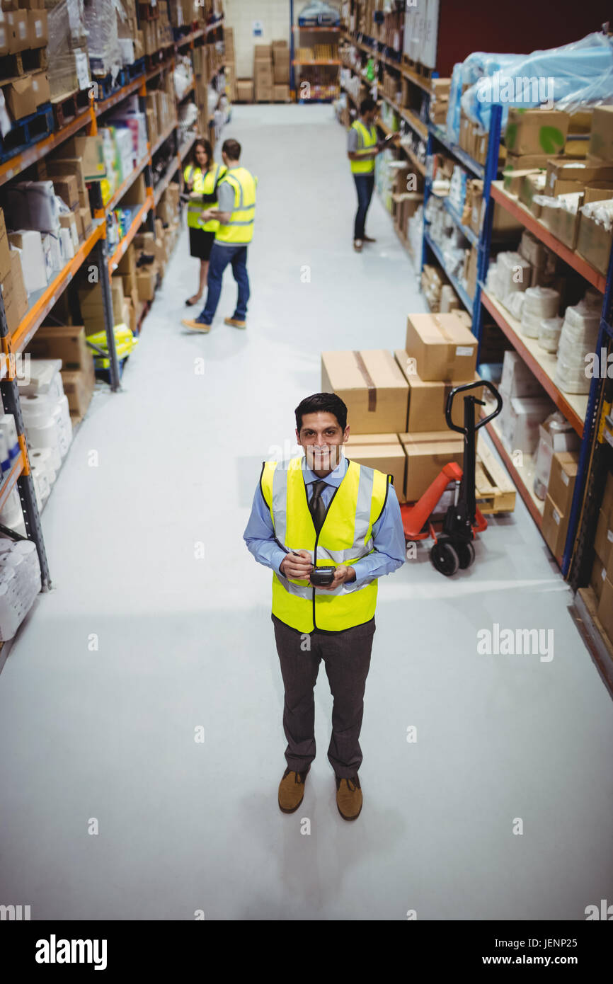 Warehouse worker using hand scanner Stock Photo - Alamy