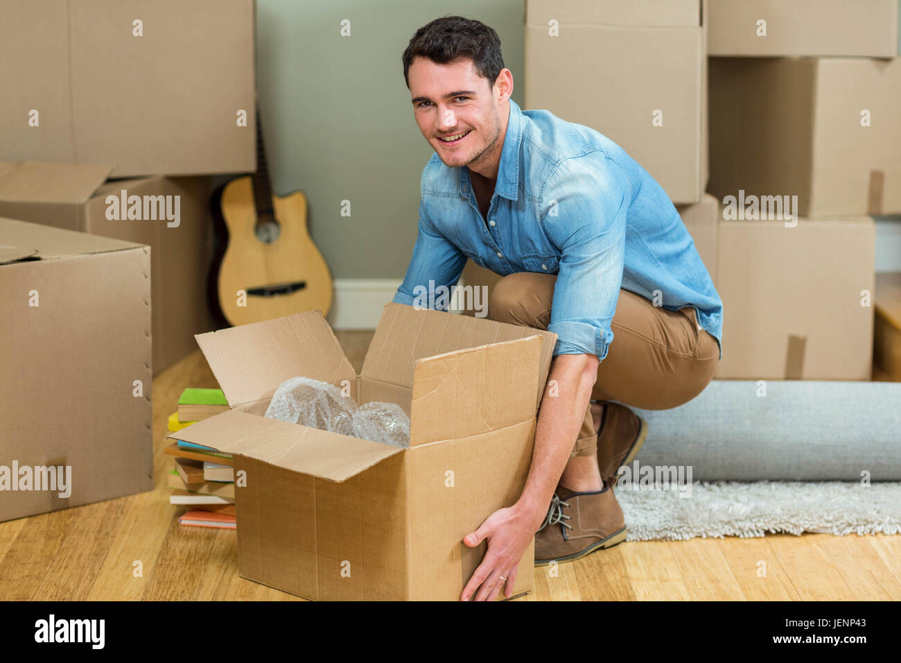 Young man carrying carton boxes Stock Photo - Alamy