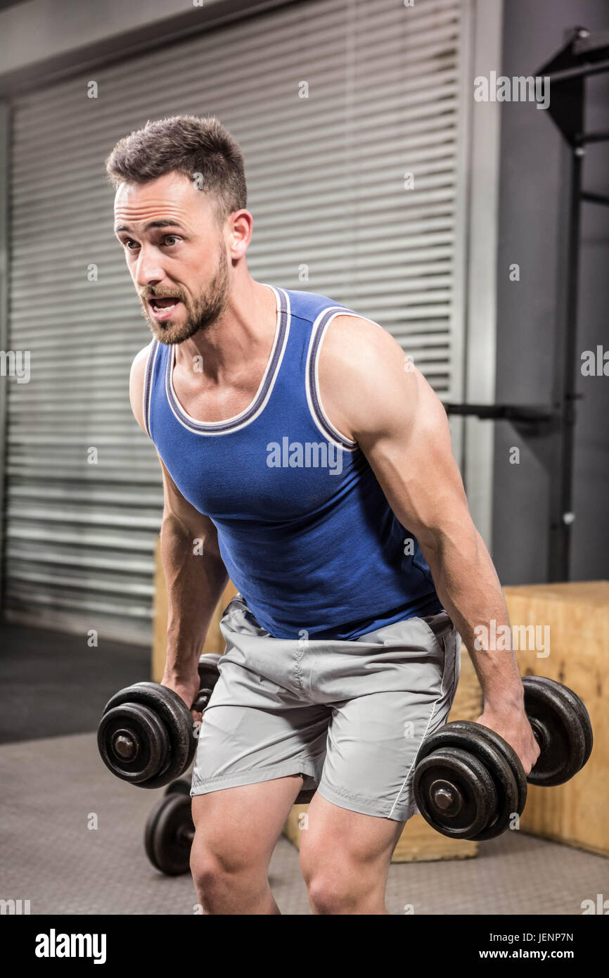 Muscular man lifting dumbbells Stock Photo - Alamy