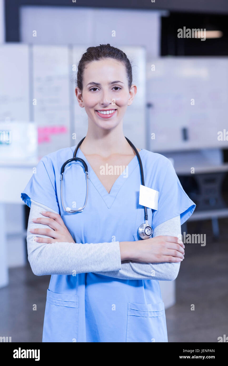 Female doctor standing with arms crossed Stock Photo - Alamy