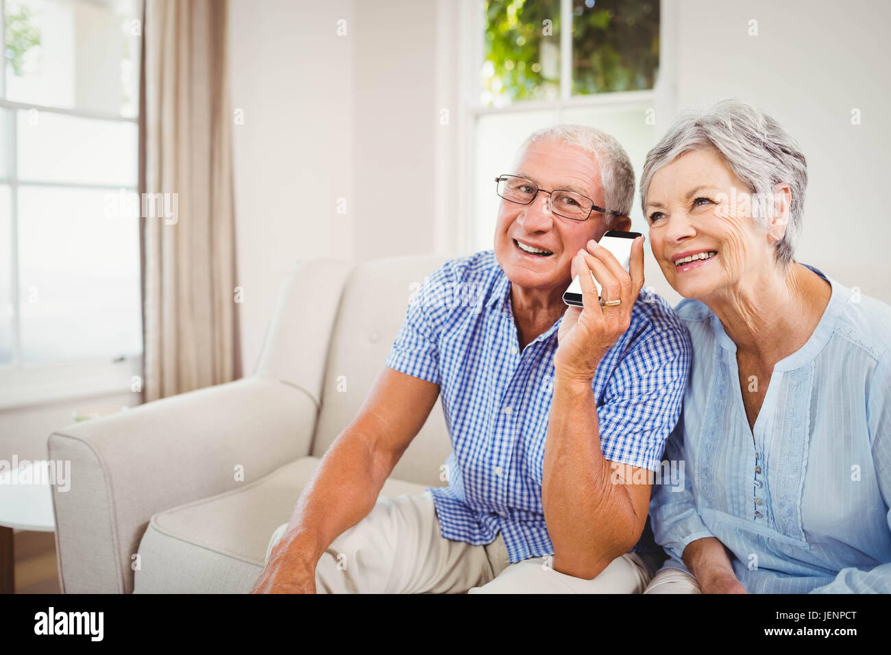 Senior couple talking on mobile phone Stock Photo - Alamy