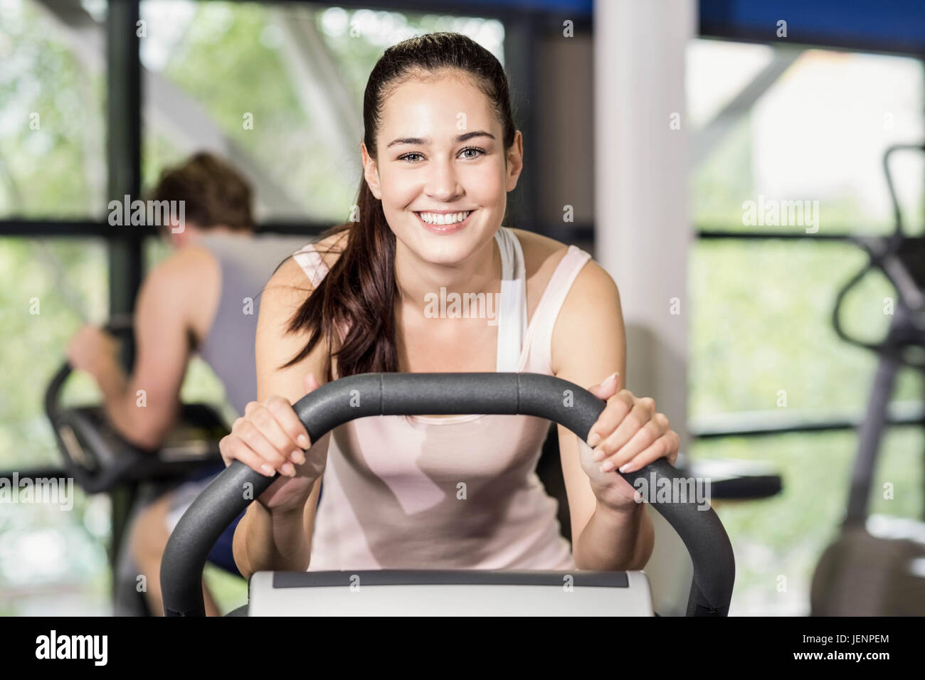 Fit woman doing exercise bike Stock Photo - Alamy