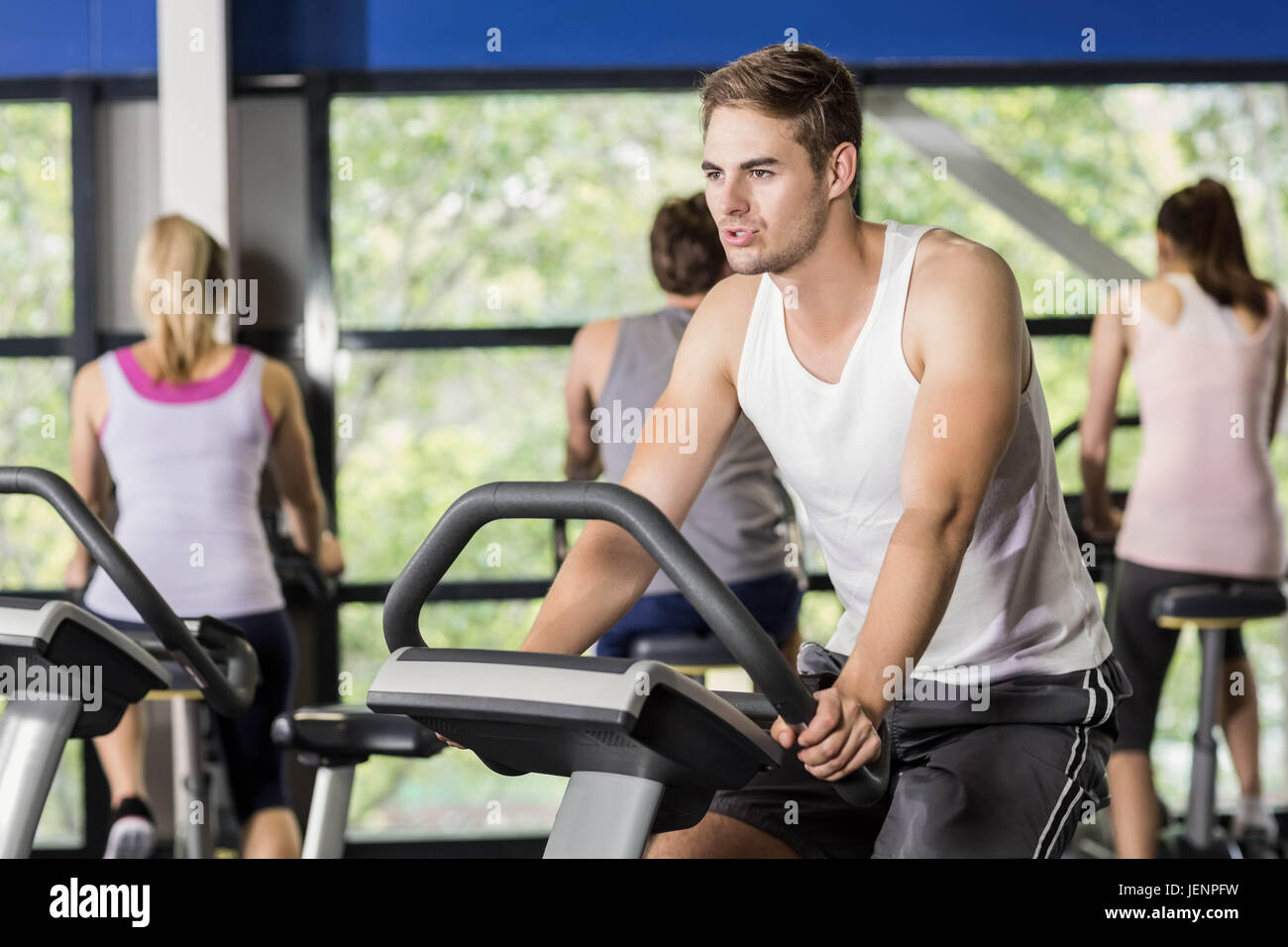 Fit man doing exercise bike Stock Photo - Alamy