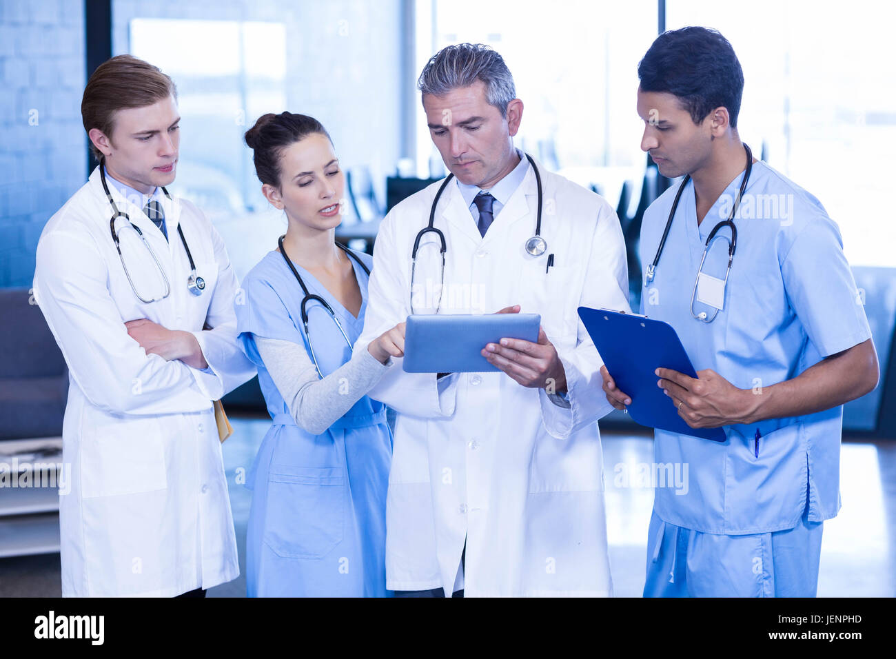Doctors looking in digital tablet Stock Photo - Alamy
