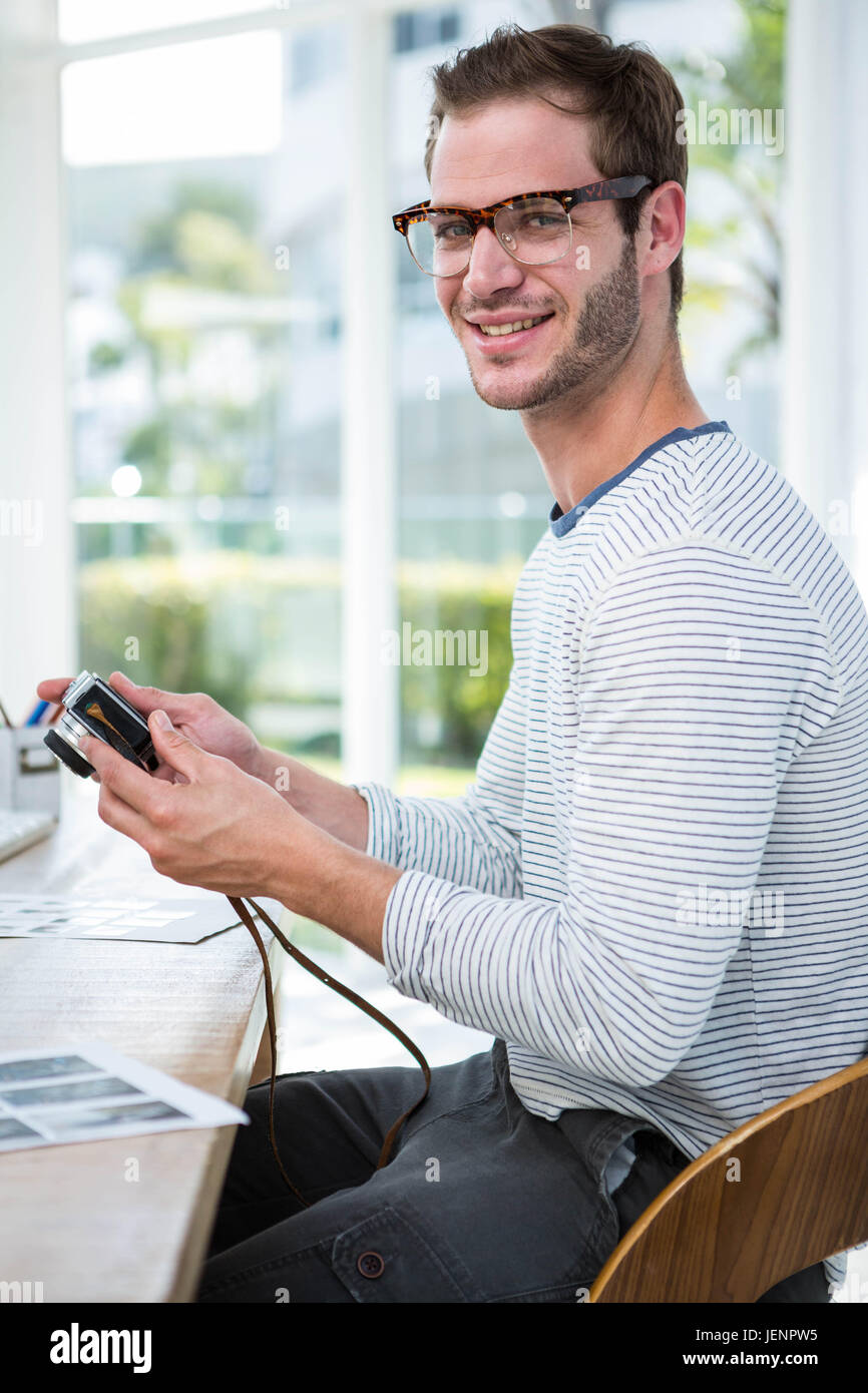 Handsome man looking at pictures on camera Stock Photo - Alamy