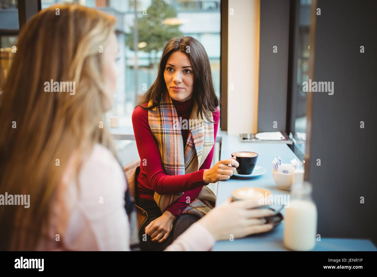 Pretty friends chatting over coffee Stock Photo - Alamy