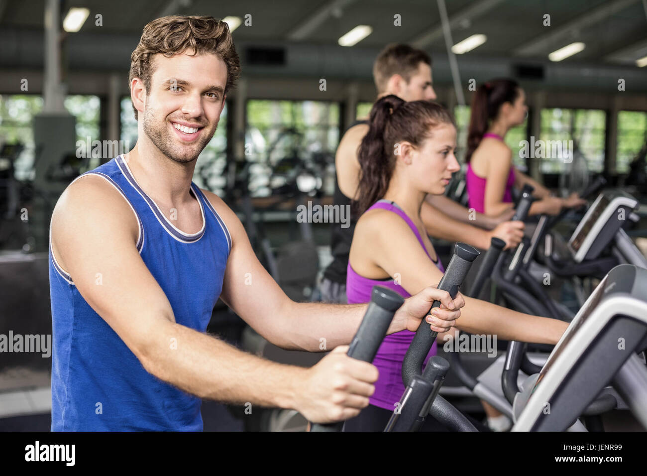 Fit people on elliptical bike Stock Photo - Alamy