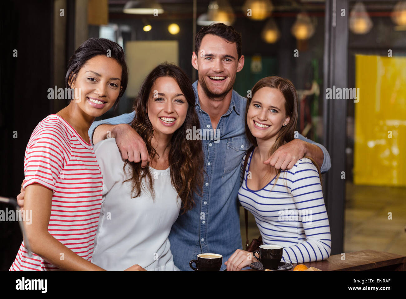Smiling friends having coffee Stock Photo - Alamy