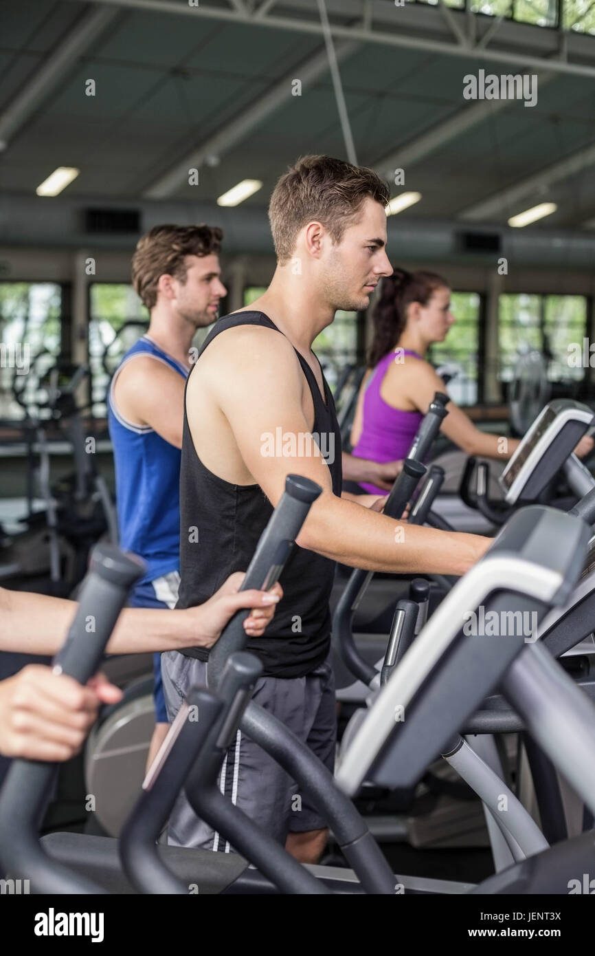 Fit people on elliptical bike Stock Photo - Alamy