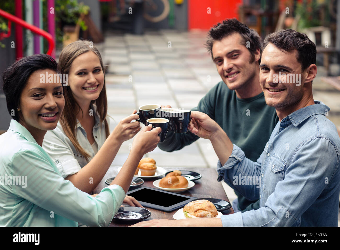 Happy friends having coffee together Stock Photo - Alamy