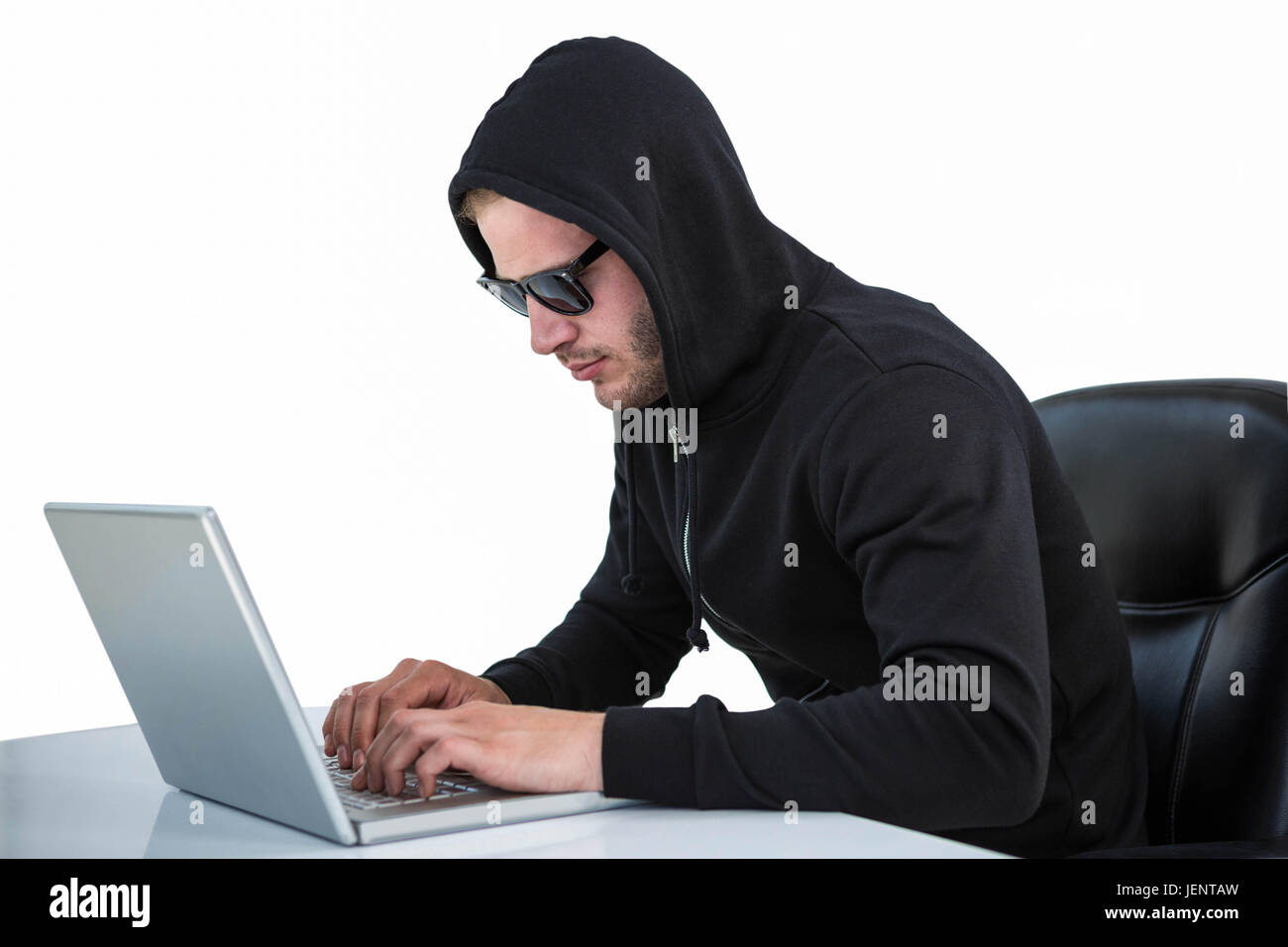Man in black hoodie using laptop Stock Photo - Alamy
