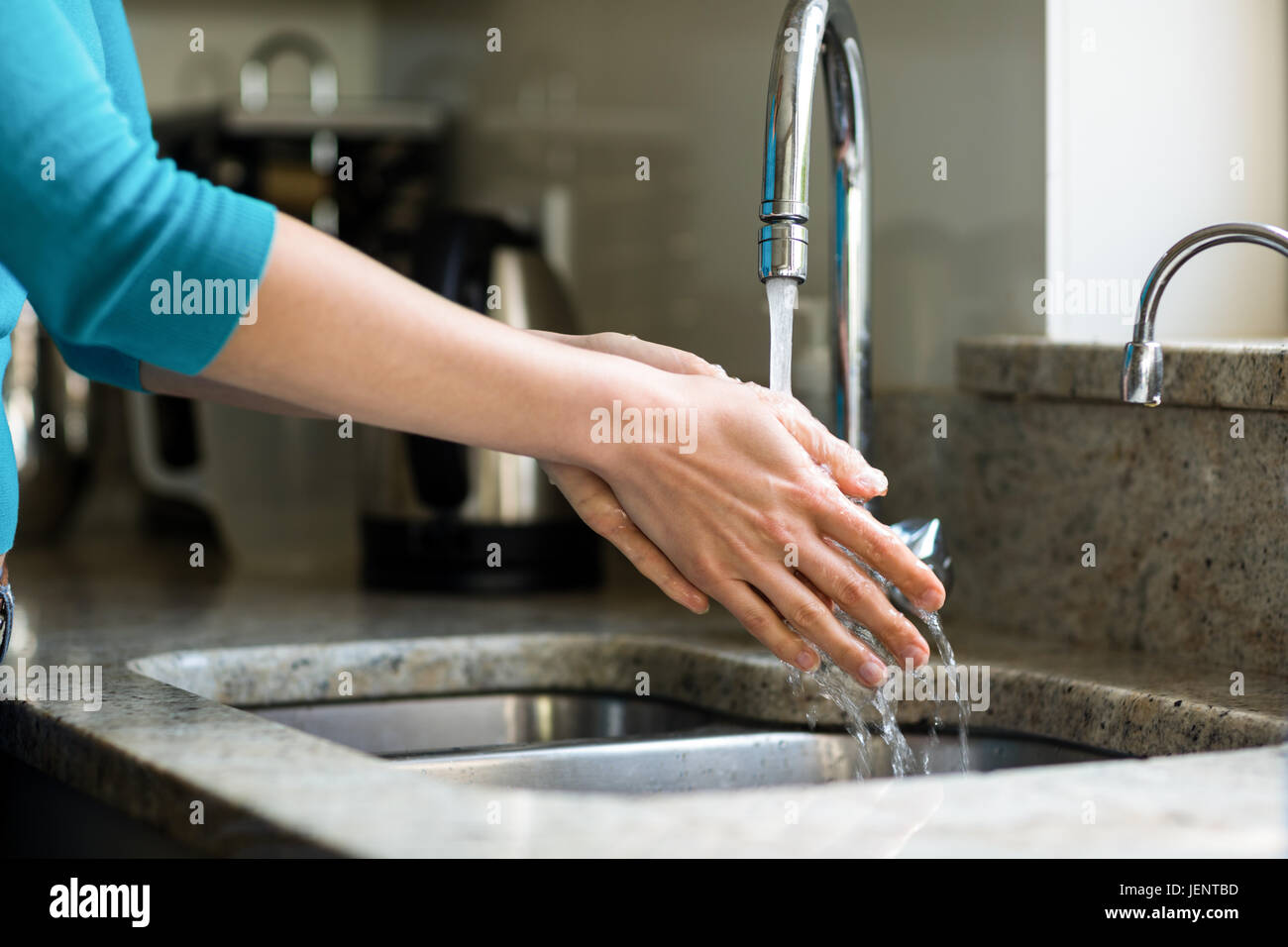 Pretty woman washing her hands Stock Photo - Alamy