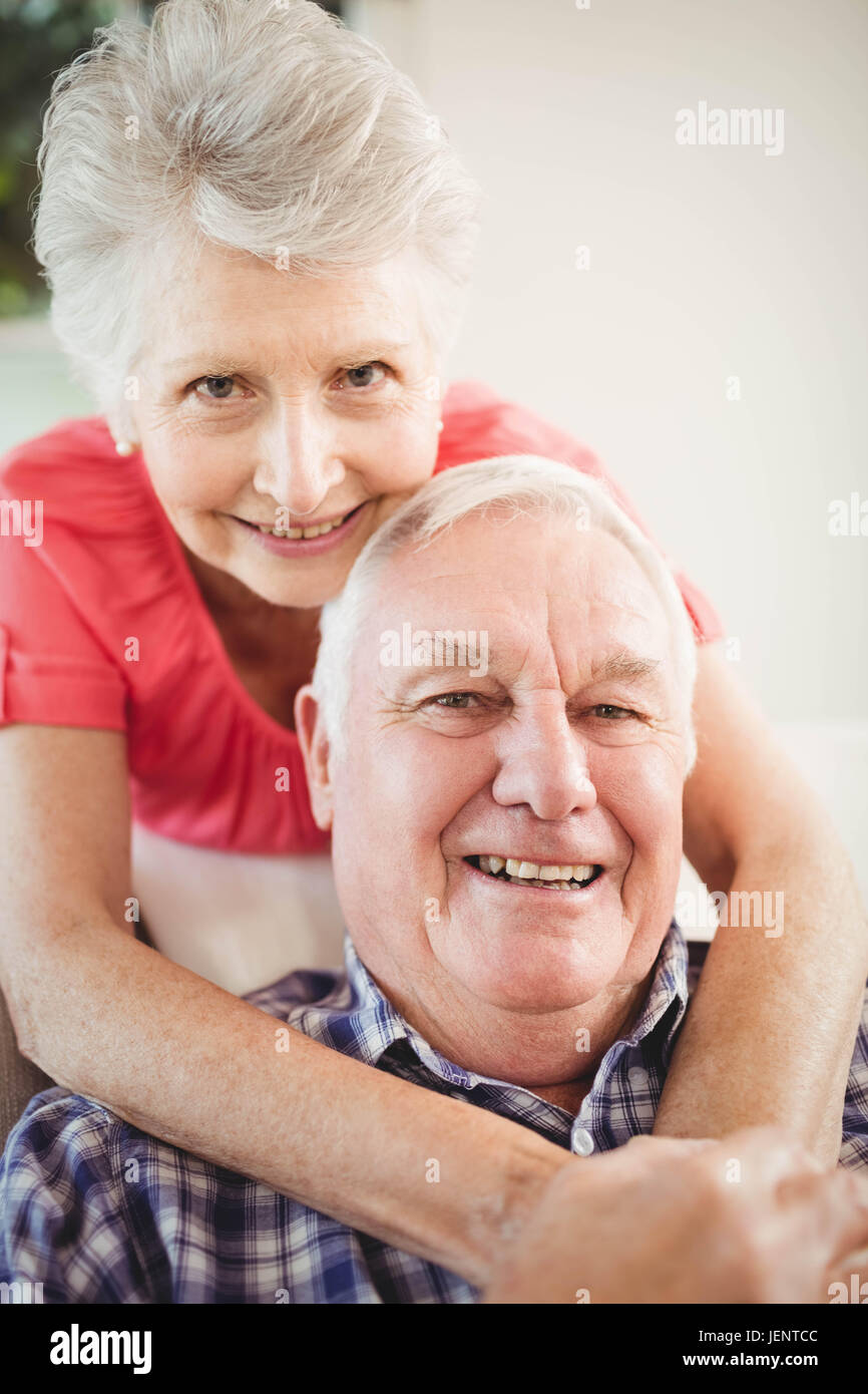 Senior woman embracing man at home Stock Photo - Alamy