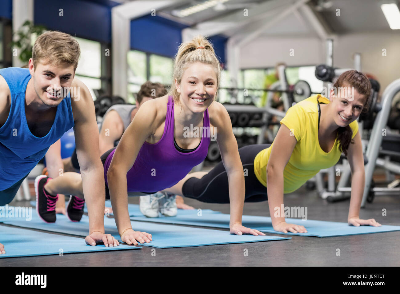 Fit people in plank position Stock Photo - Alamy