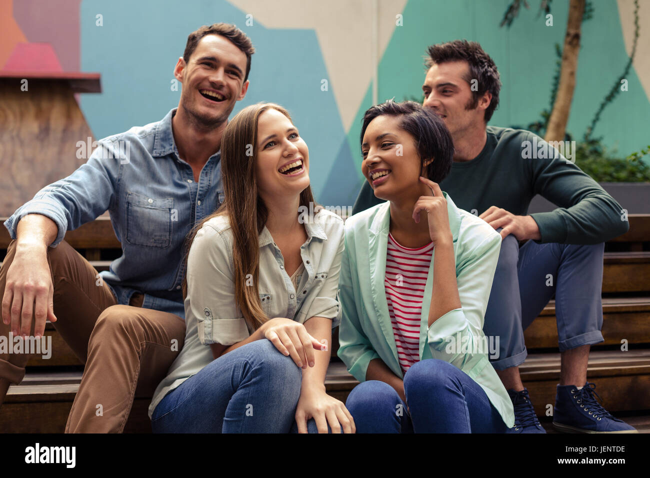 Happy friends talking Stock Photo - Alamy