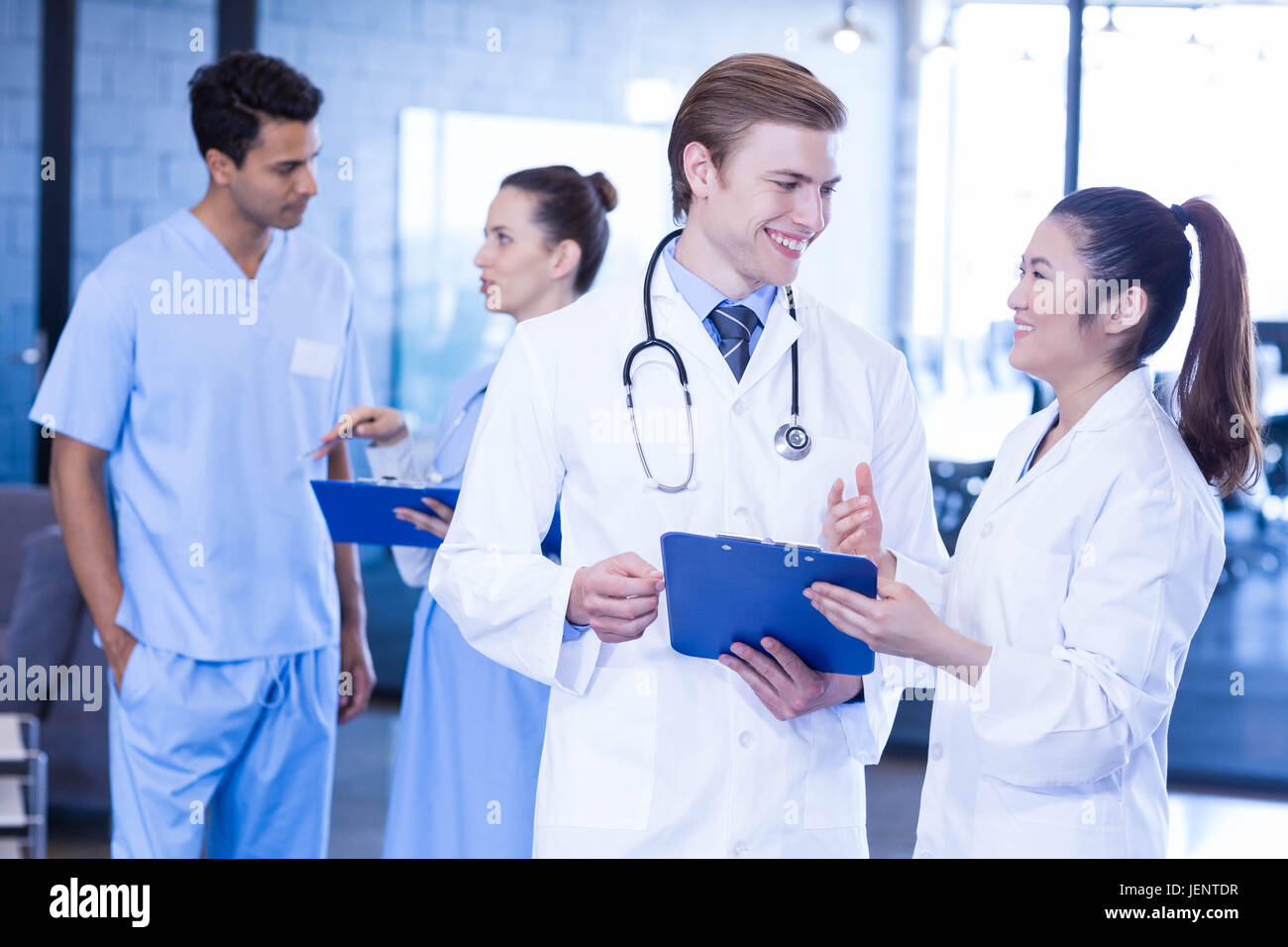 Doctors looking at medical report Stock Photo - Alamy