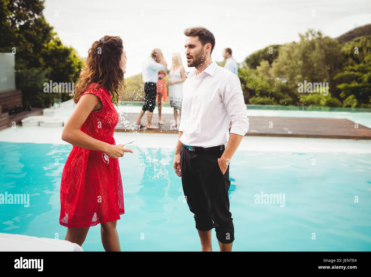 Friends talking near pool Stock Photo - Alamy