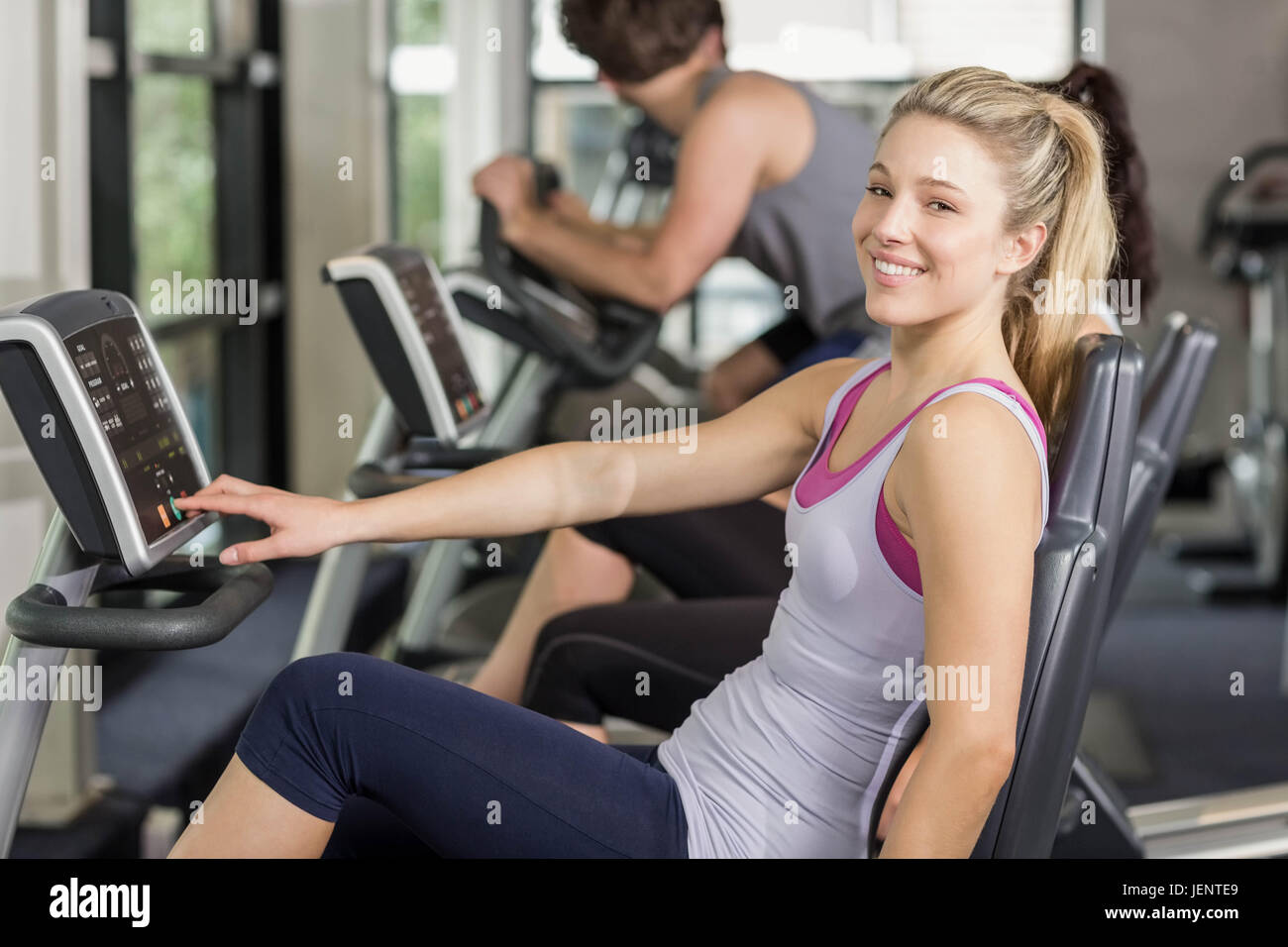 Fit people doing exercise bike Stock Photo - Alamy