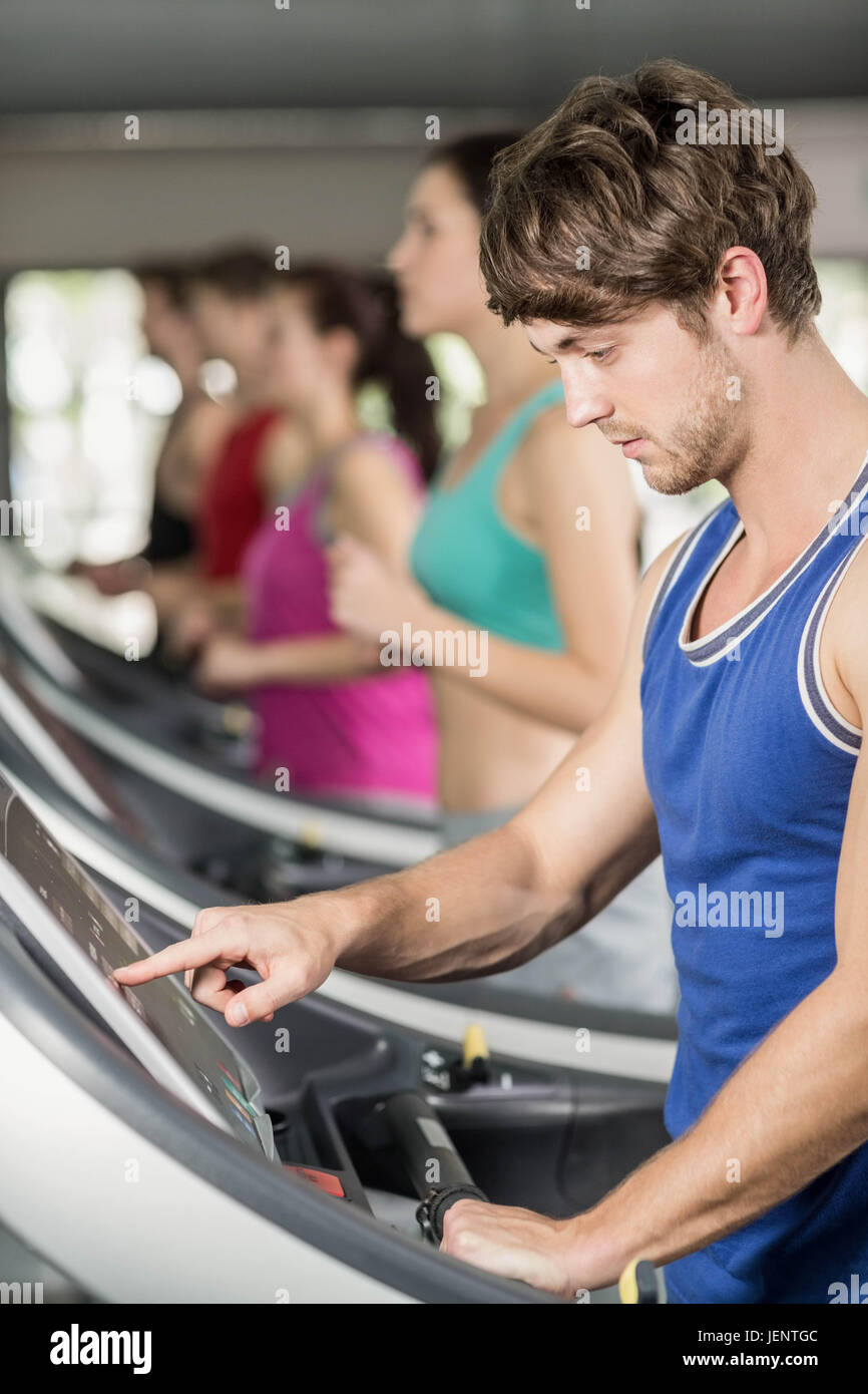 Smiling muscular man on treadmill Stock Photo - Alamy