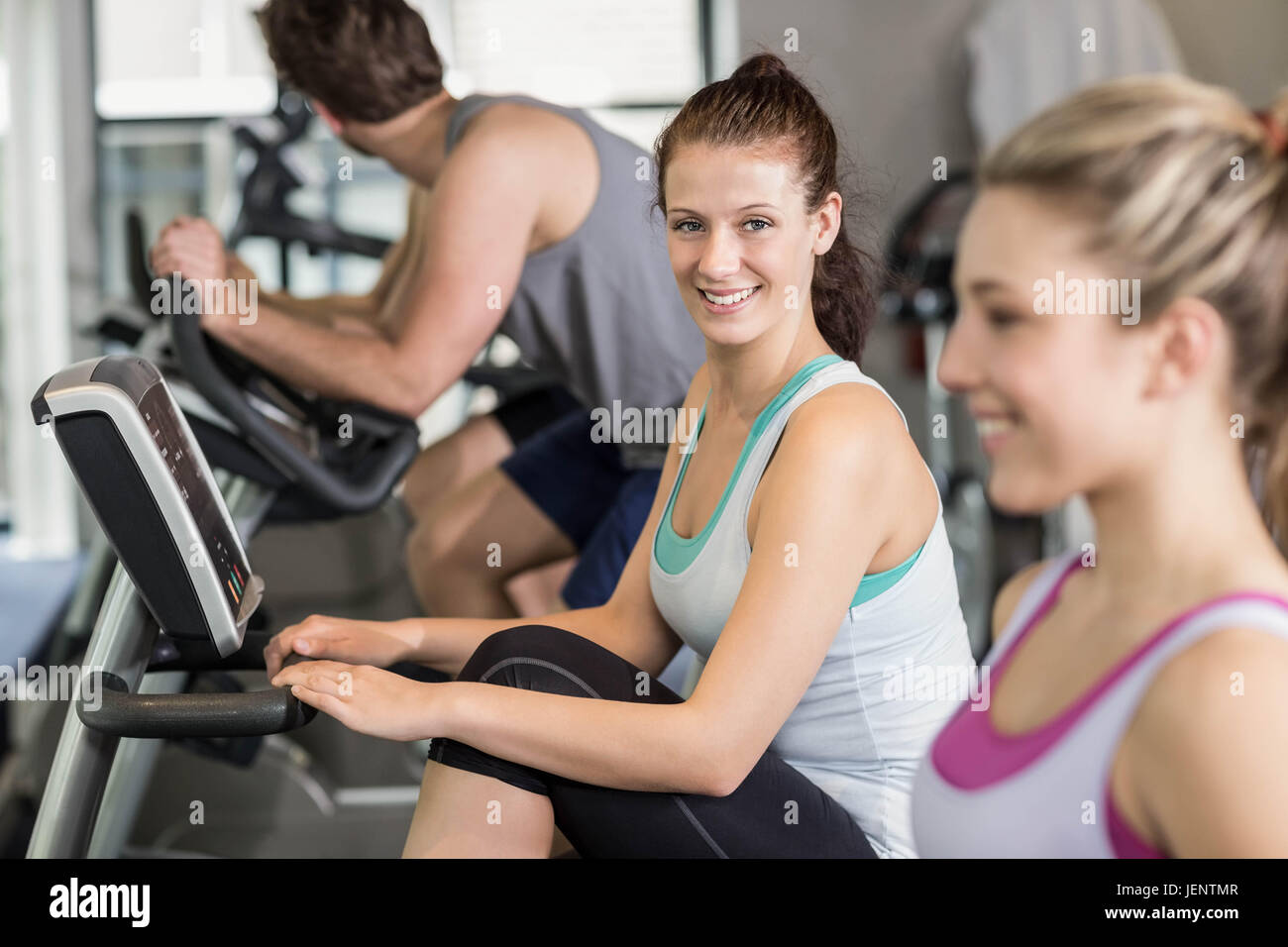 Fit people doing exercise bike Stock Photo - Alamy