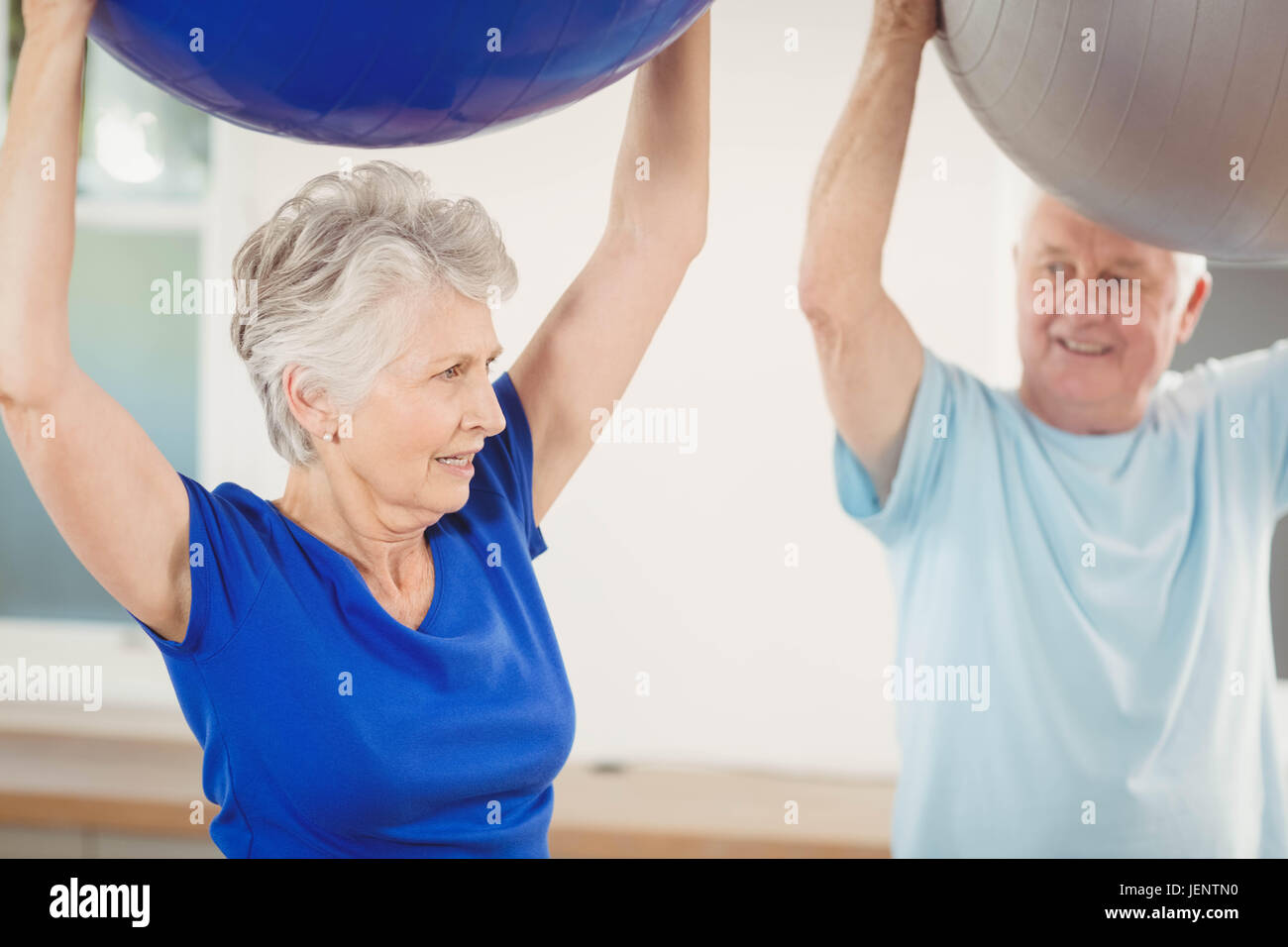Senior couple exercising with exercise ball Stock Photo - Alamy