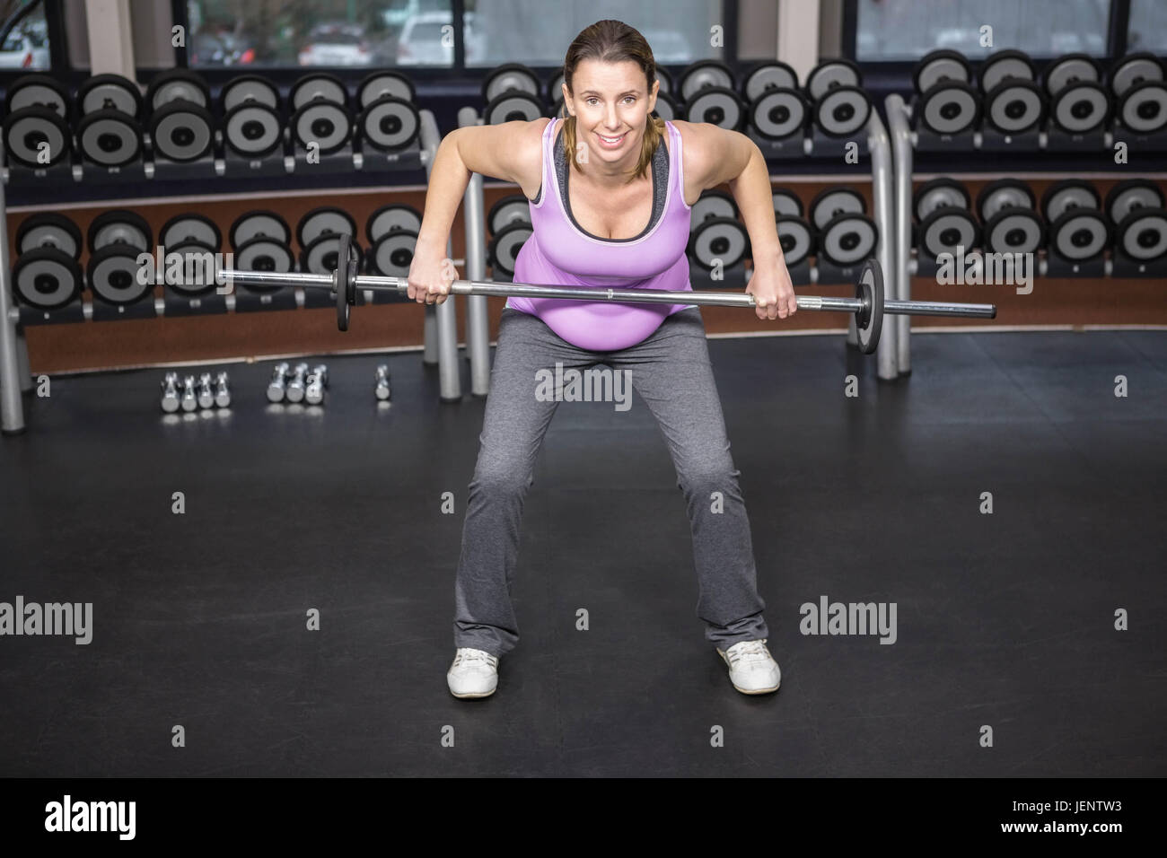 Pretty woman lifting barbell hi-res stock photography and images - Alamy
