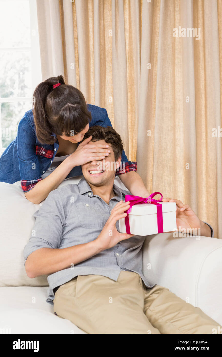 Young man receiving a surprise gift Stock Photo - Alamy