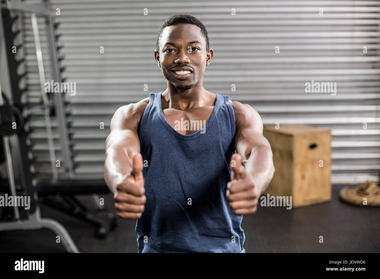 Fit man with thumbs up Stock Photo - Alamy