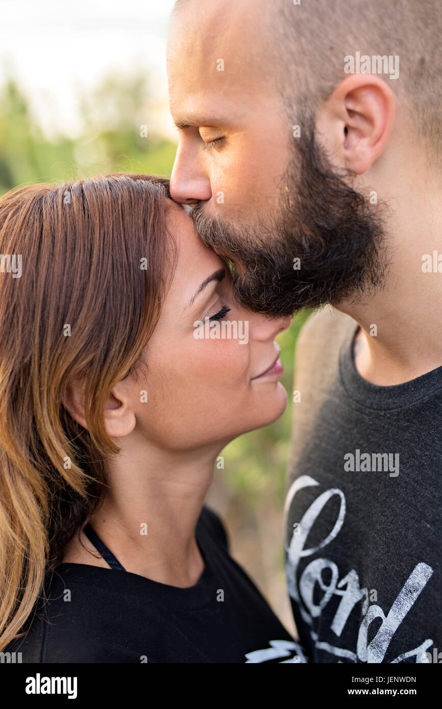 Young couple kissing Stock Photo - Alamy