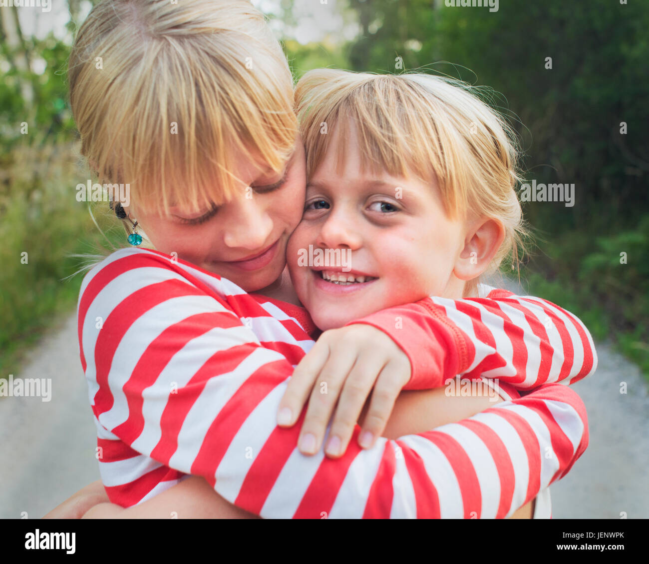 Blonde sisters hugging hi-res stock photography and images - Alamy
