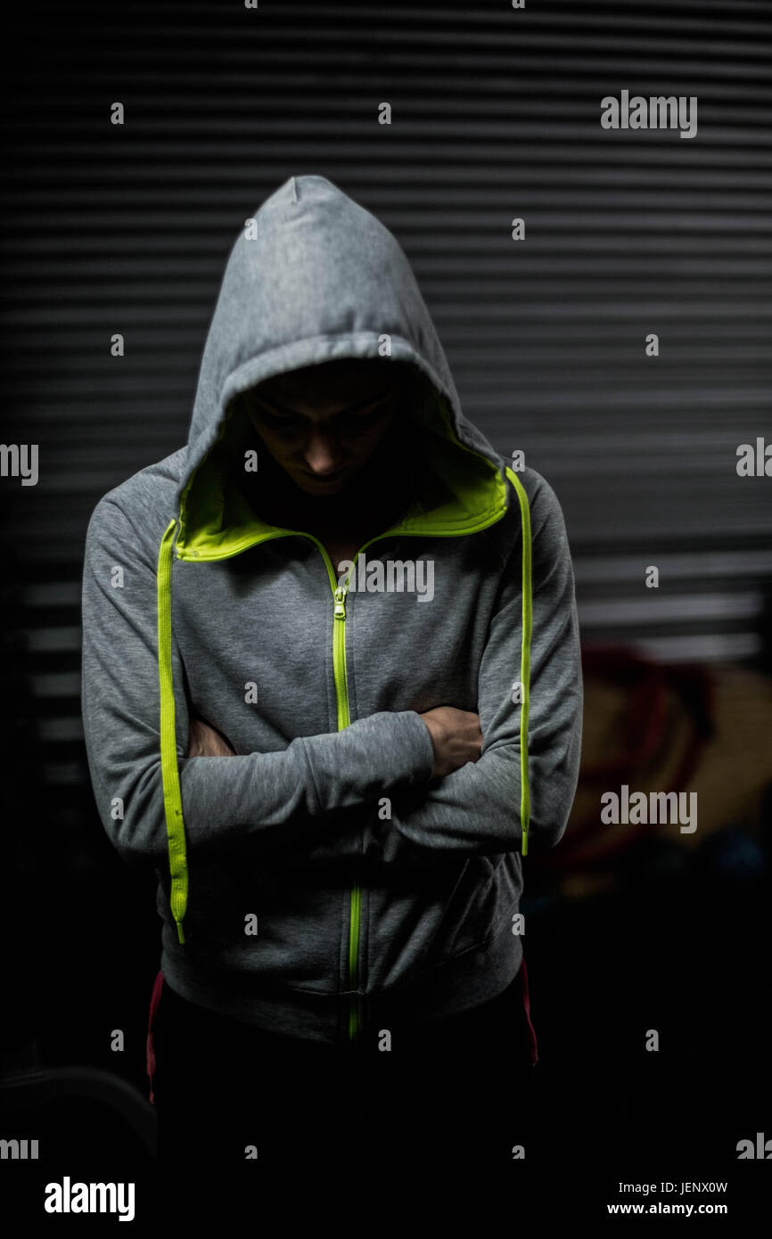 Athlete wearing hood with head down Stock Photo - Alamy