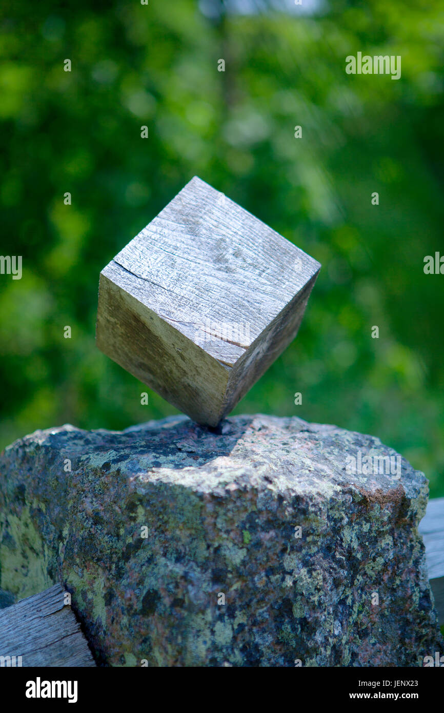 Wooden cube on top of the stone Stock Photo - Alamy