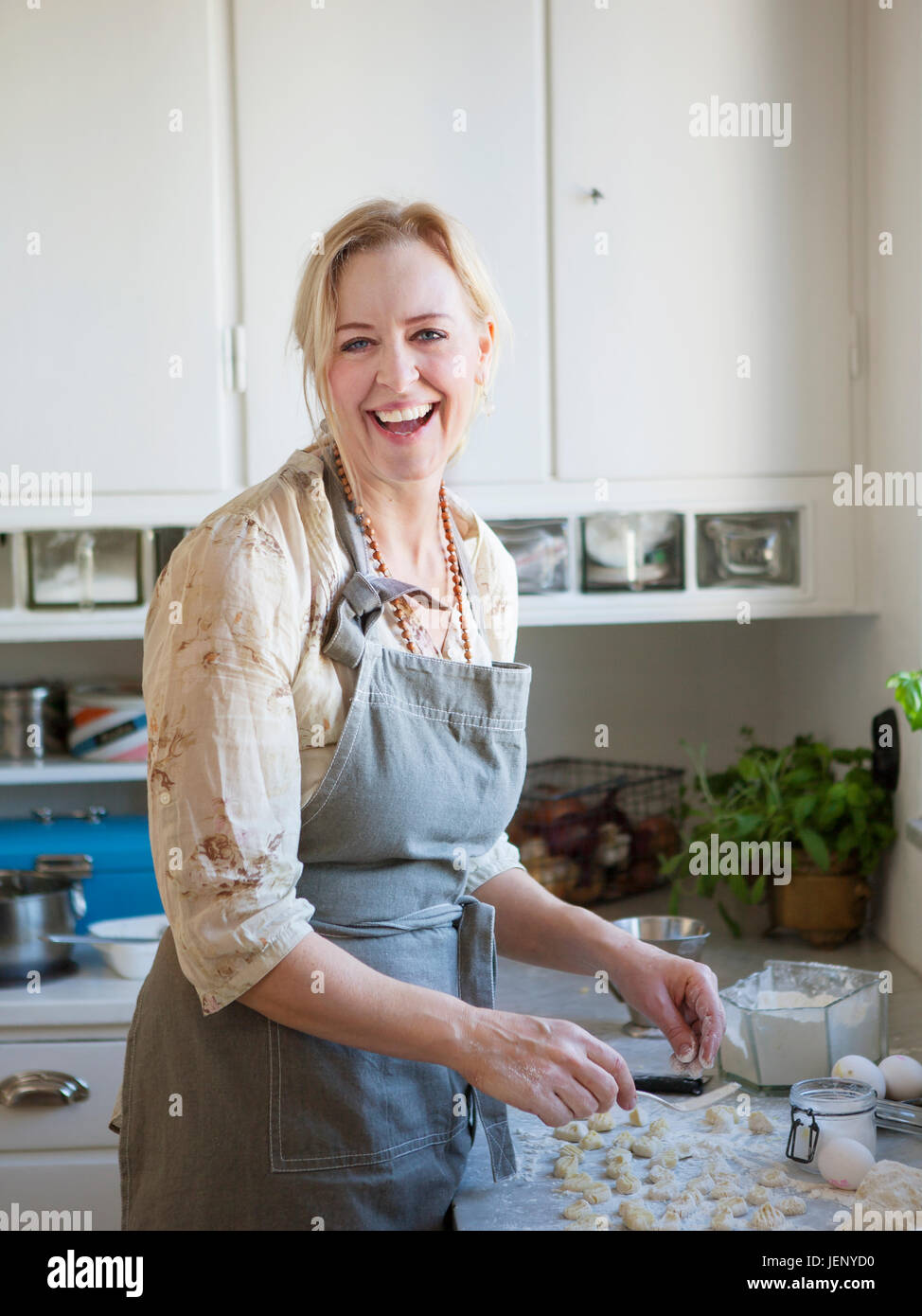 Laughing woman cooking Stock Photo - Alamy