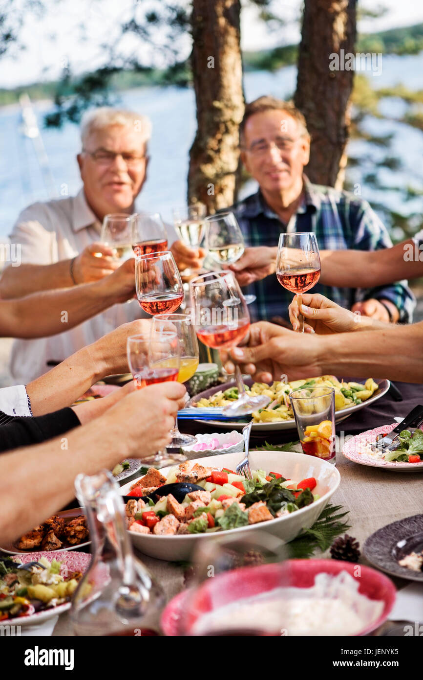People toasting during meal Stock Photo - Alamy