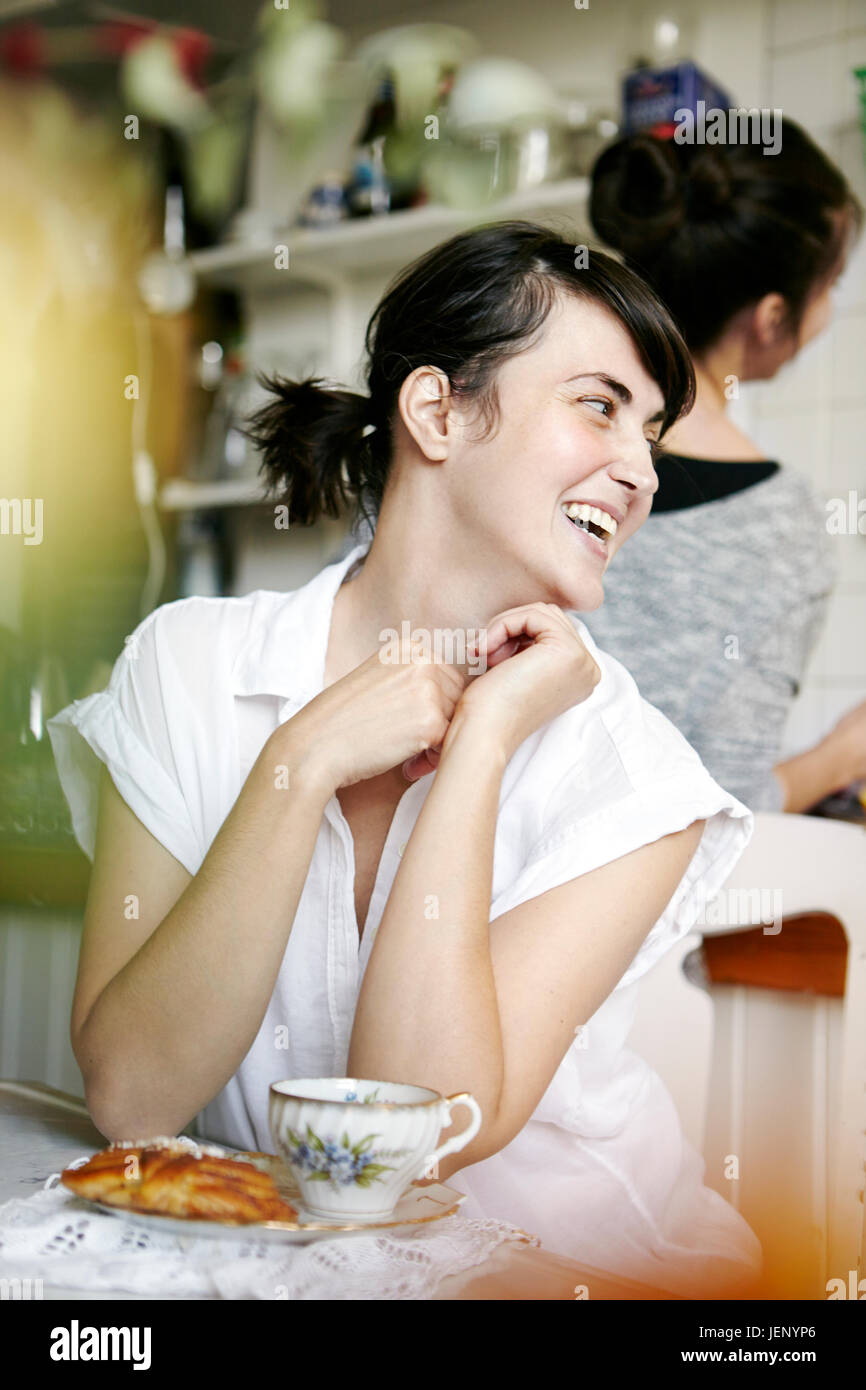 Happy young woman having tea Stock Photo - Alamy