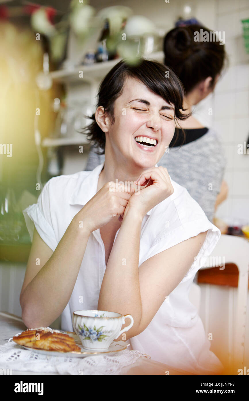 Happy young woman having tea Stock Photo - Alamy