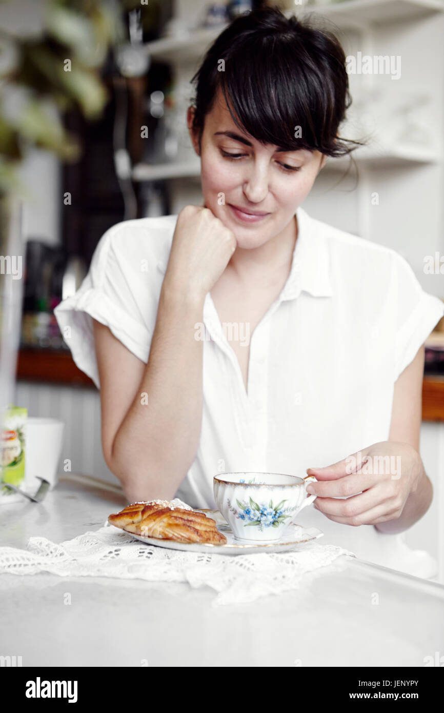 Young woman having tea Stock Photo - Alamy