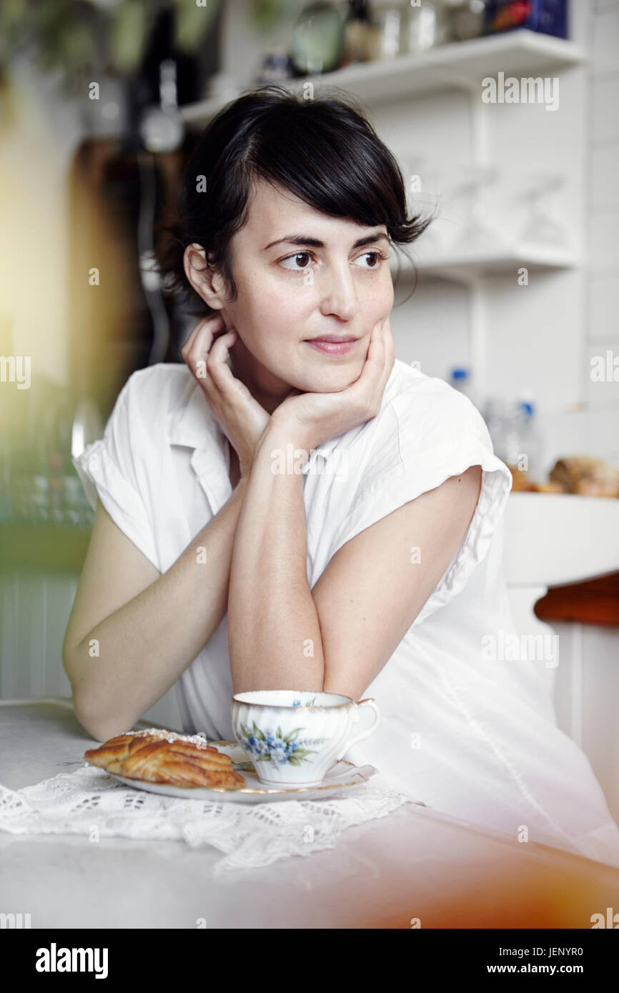 Young woman having tea Stock Photo - Alamy