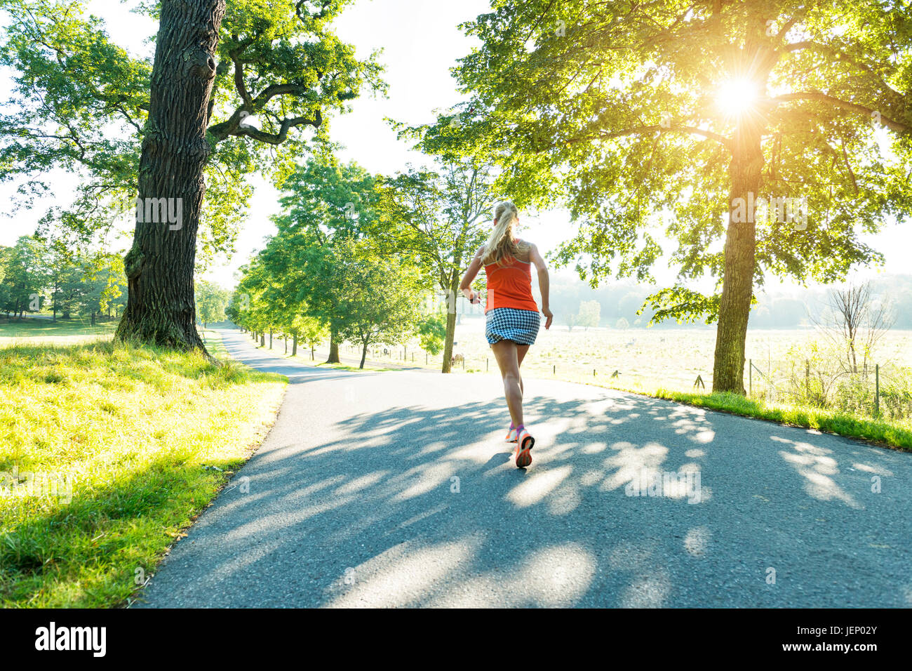 Back view blonde woman running hi-res stock photography and images - Alamy