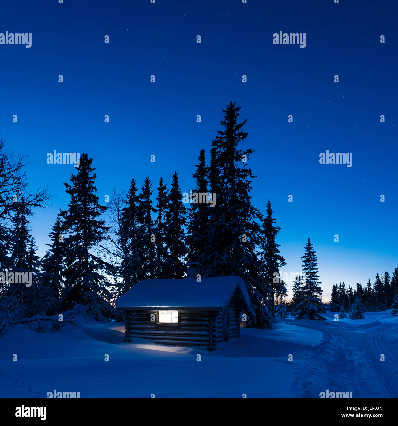 Illuminated log house at night Stock Photo - Alamy