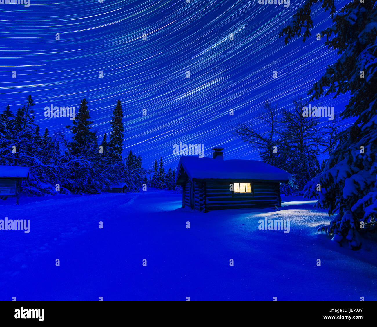 Illuminated log house at night Stock Photo - Alamy